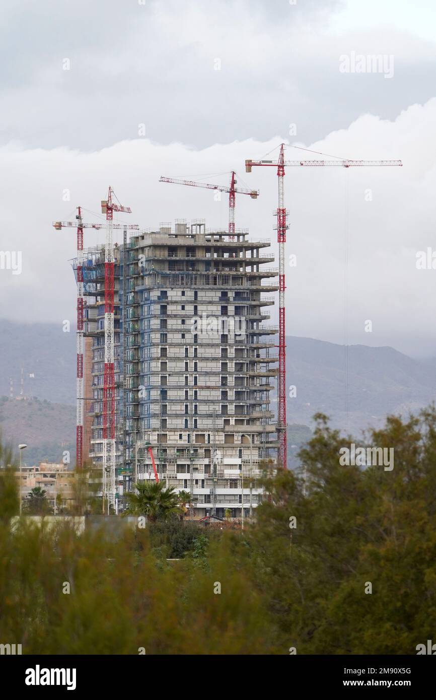 High-rise buildings, tower block, surrounded by cranes in Malaga under ...