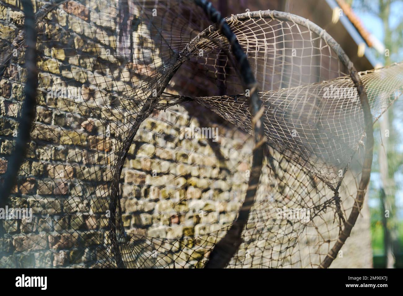 An old fishing trap hanging to dry Stock Photo - Alamy