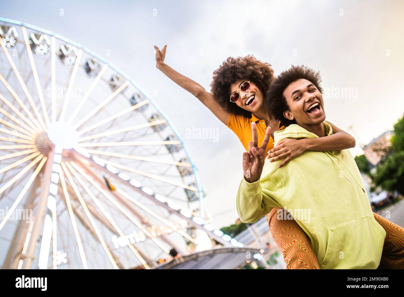 Multiracial young couple of lovers dating at theferry wheel in the ...