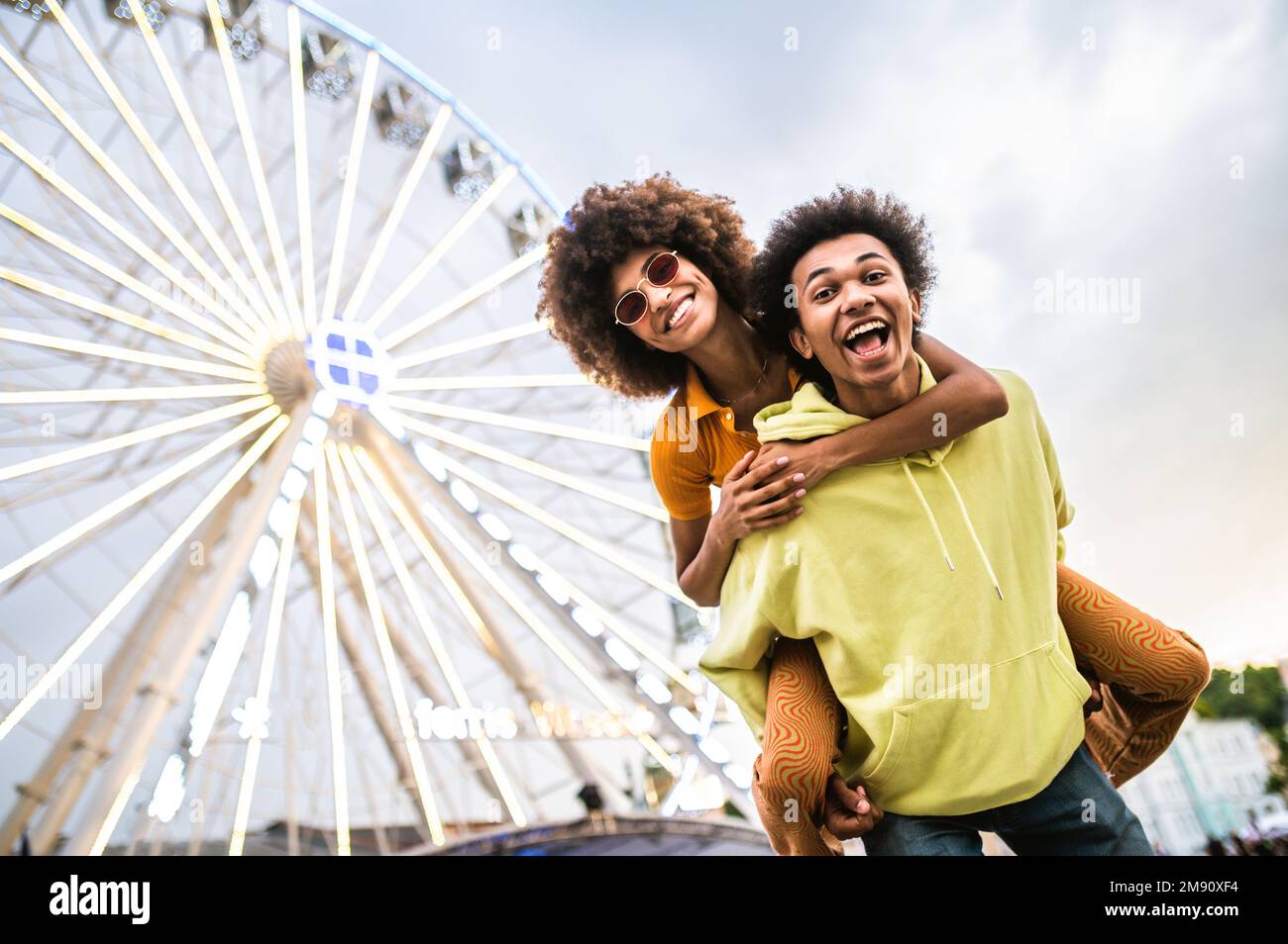 Multiracial young couple of lovers dating at theferry wheel in the ...