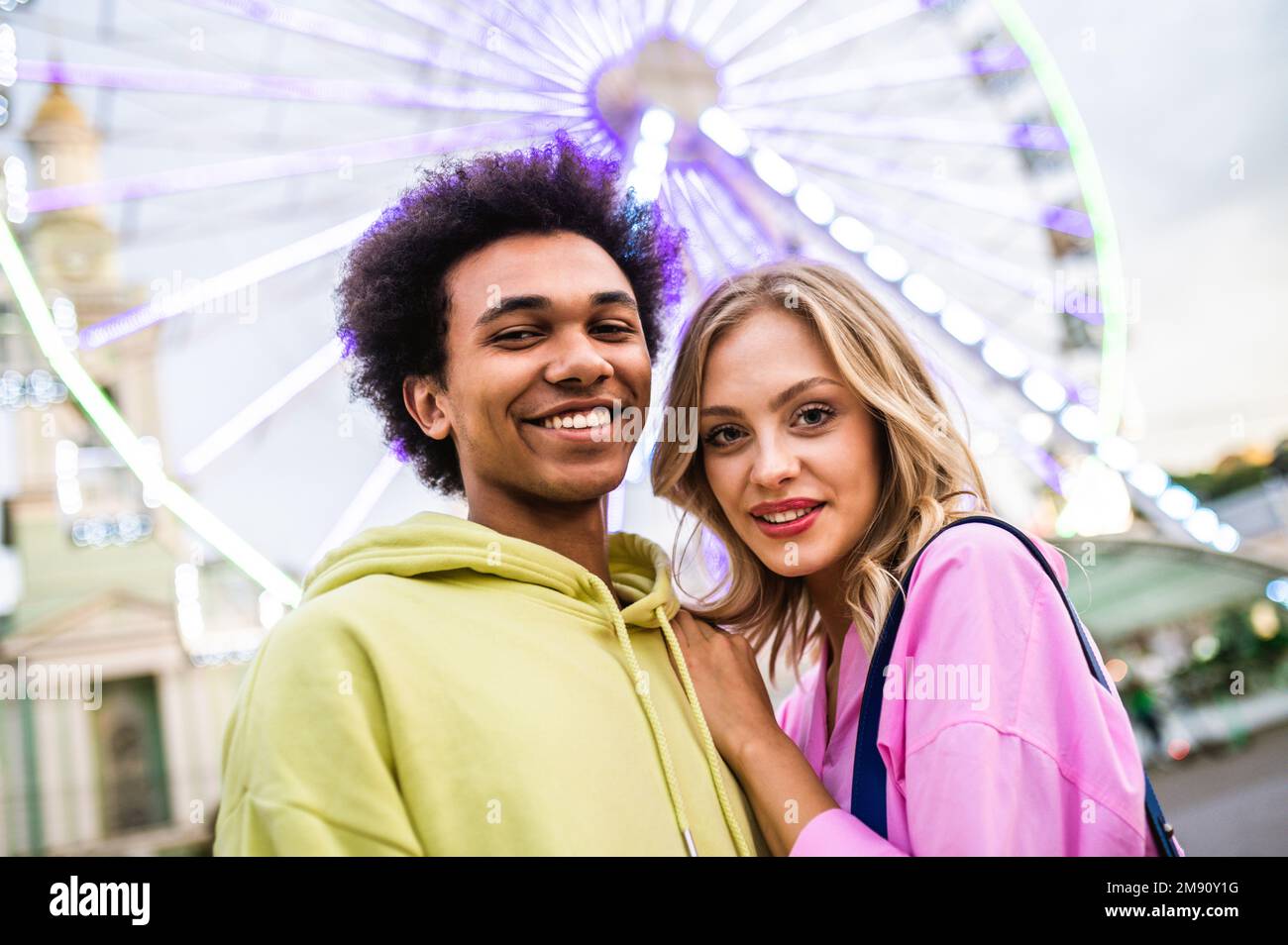 Multiracial young couple of lovers dating at theferry wheel in the ...