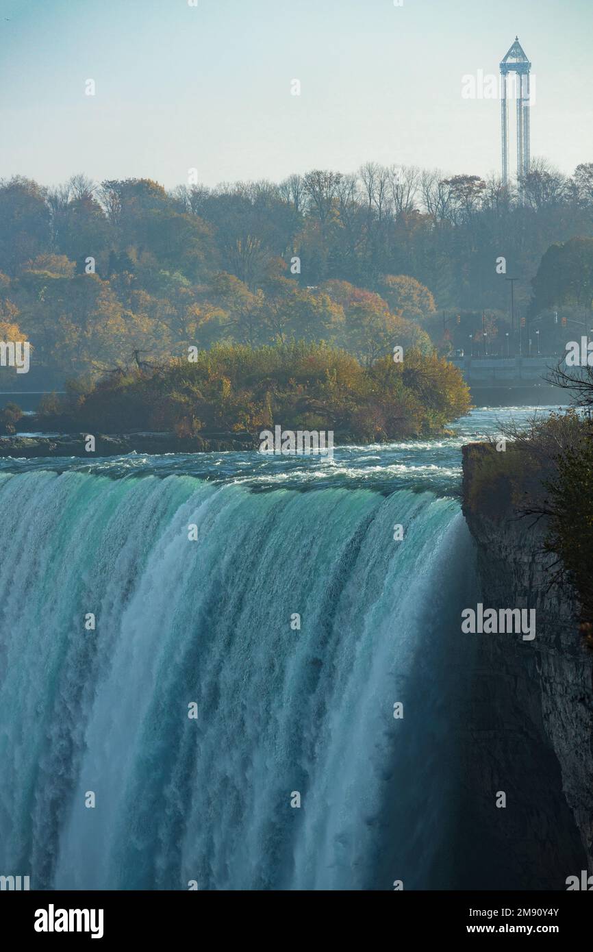 A vertical closeup shot of Niagara Falls before autumn trees in Ontario ...