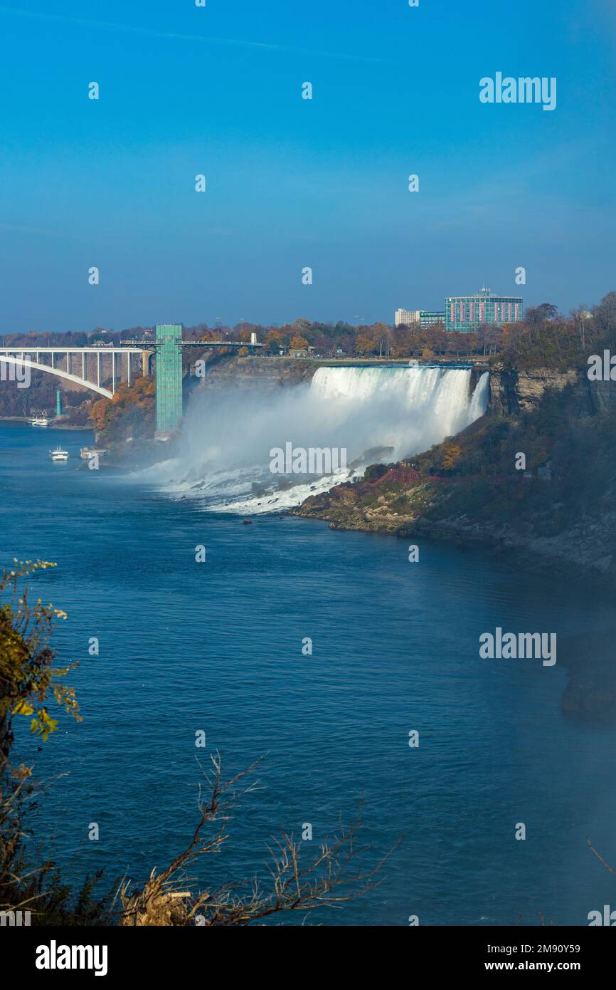 A vertical distant shot of Niagara Falls and the Rainbow Bridge under ...