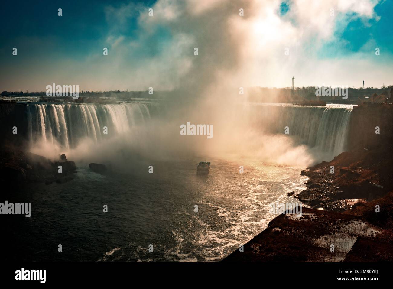 An aerial shot of Niagara Falls and steam rising from a high stream of ...