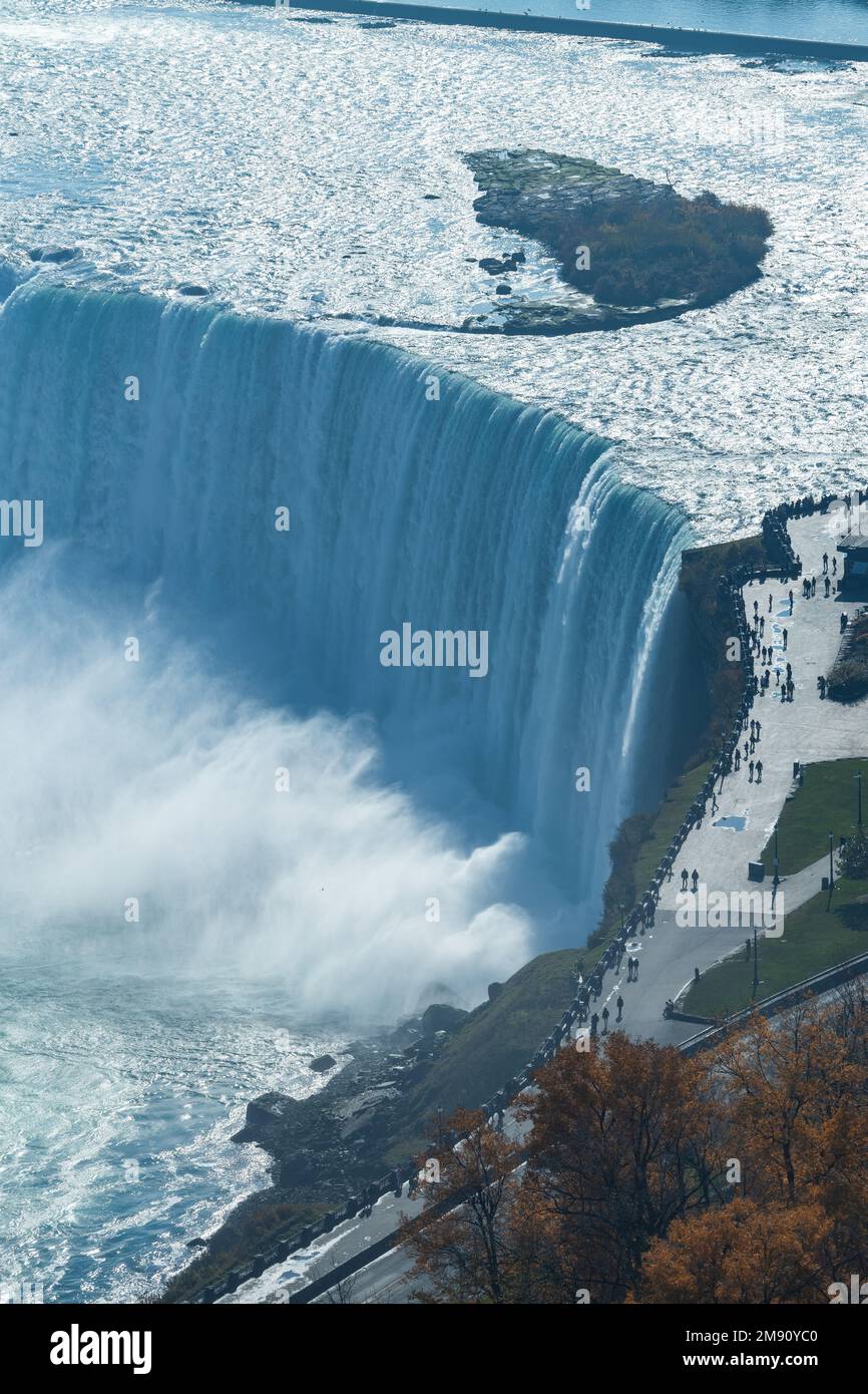 A vertical aerial shot of Niagara Falls and people admiring the view in ...