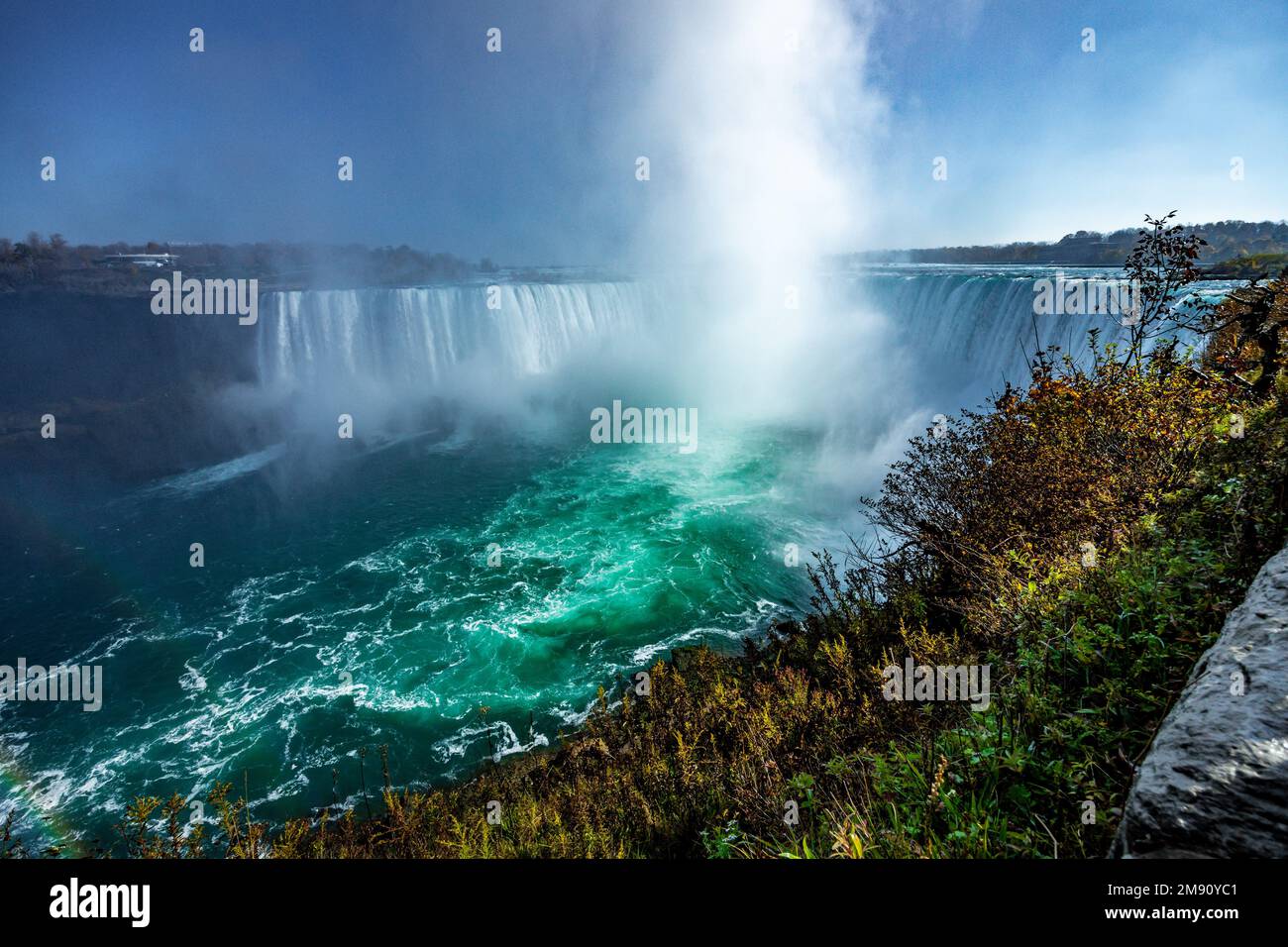 An aerial shot of Niagara Falls and steam coming out of the waterfall ...