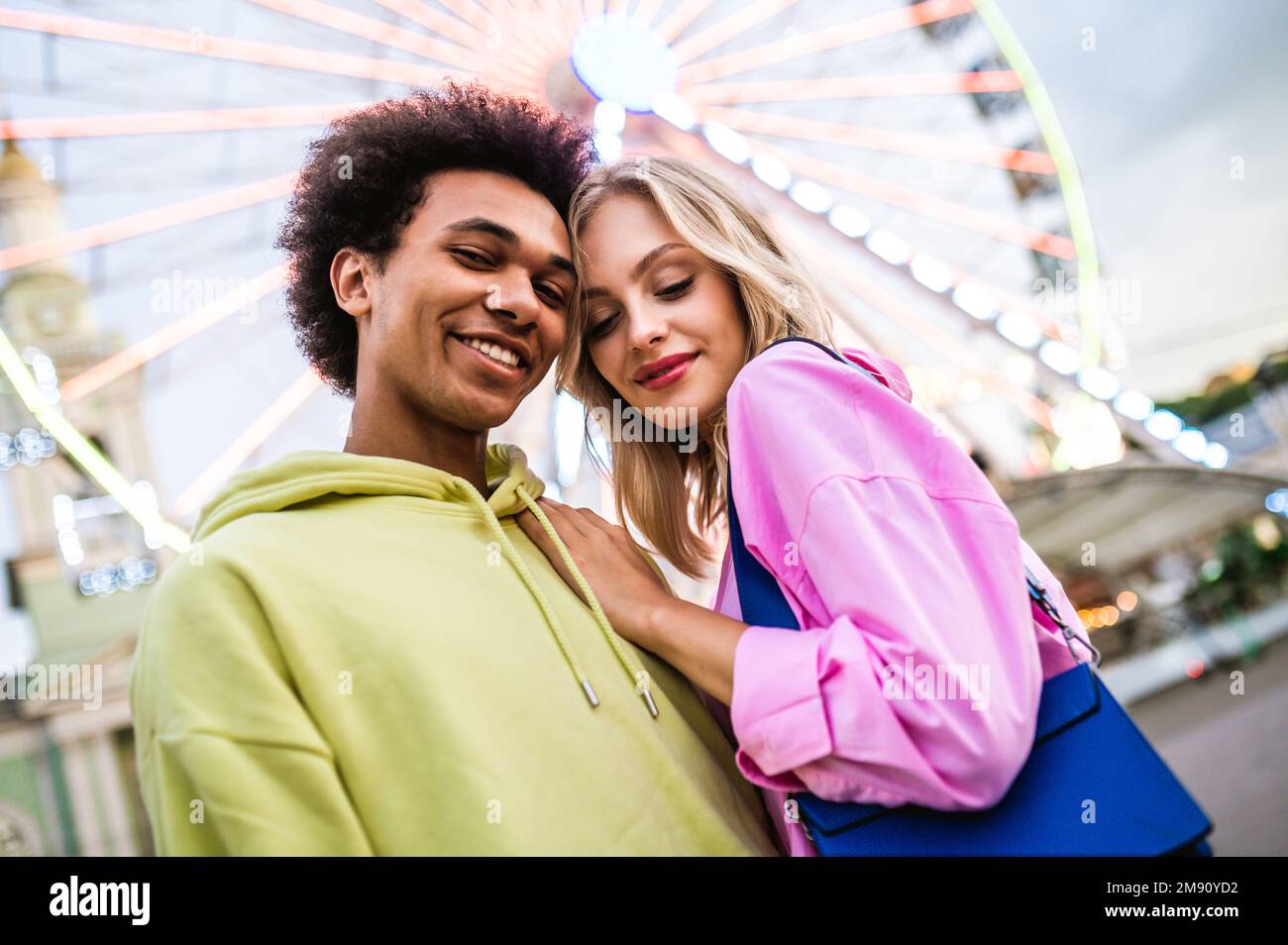 Multiracial young couple of lovers dating at theferry wheel in the ...
