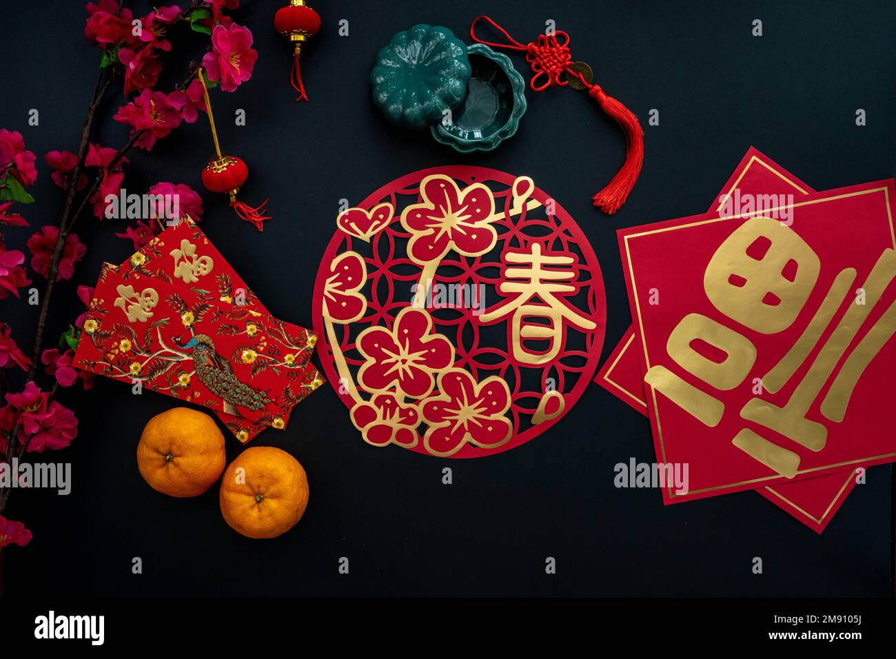Chinese lunar new year decoration over black background. Flat lay ...