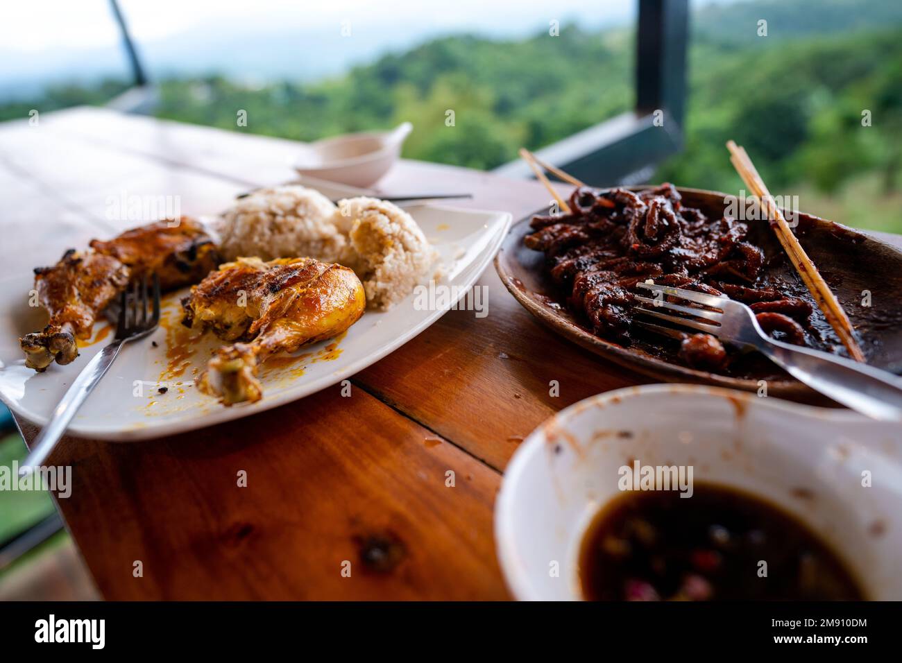 Eating chicken inasal and isaw while enjoying the overlooking view of ...