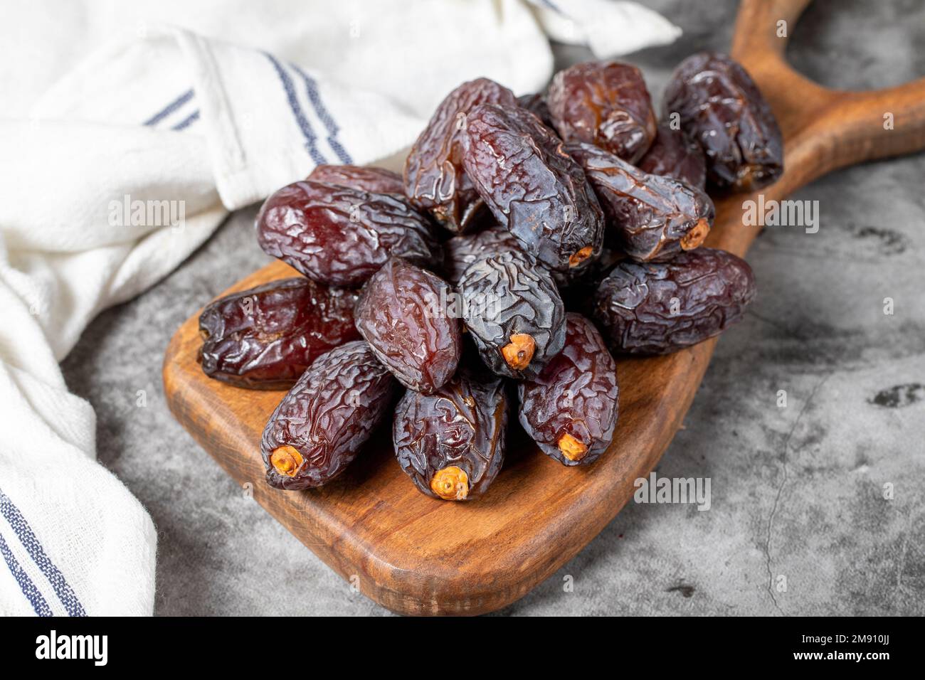 Jerusalem date fruit on stone background. Large date fruit on a wooden ...