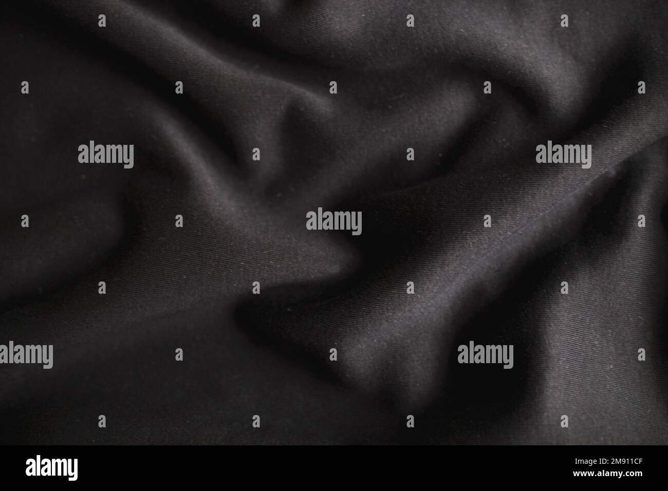 black wrinkled plush fabric background texture, soft material pattern ...