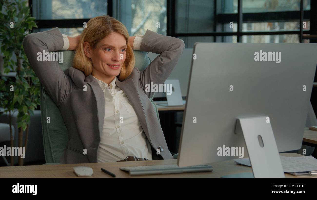 Middle-aged adult Caucasian woman 40s satisfied businesswoman finished ...