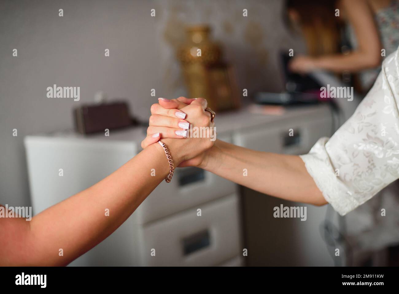 mother and daughter hold hands firmly, preserving family values Stock ...