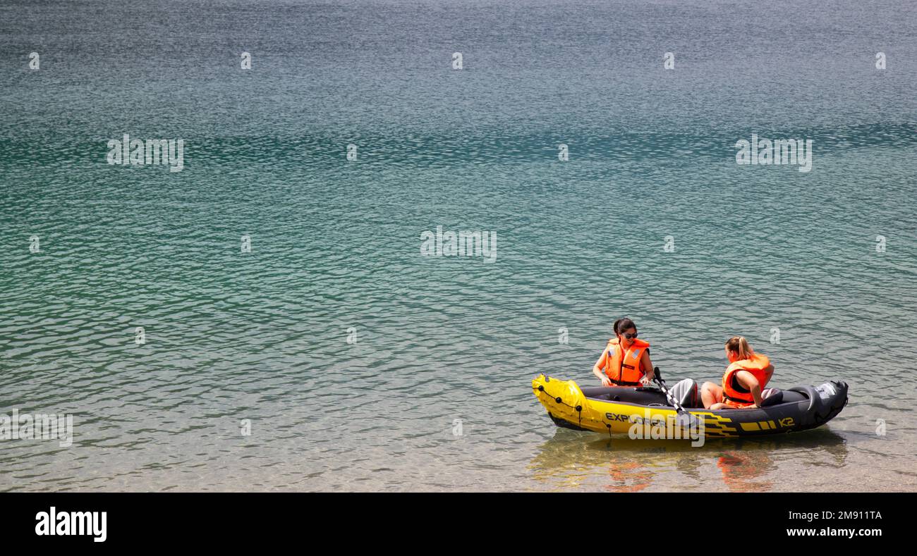 Seascape with people on inflatable canoe Stock Photo - Alamy