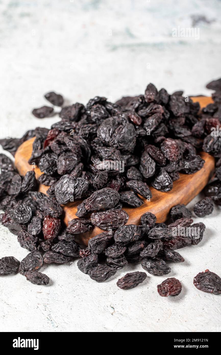 Dried black grapes on stone background. Dried grapes on a wooden ...