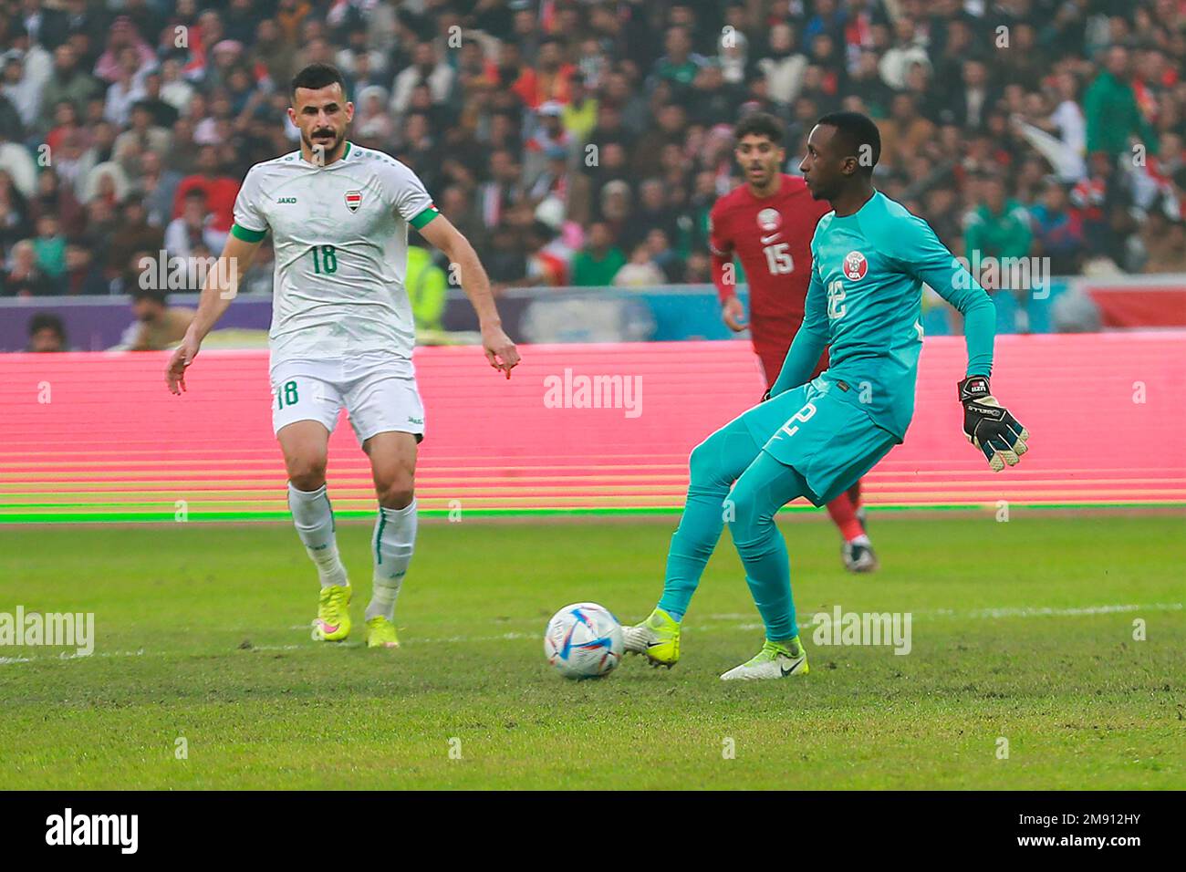 Iraq's Ayman Hussein, left, battles for the ball with Qatar's Meshaal ...