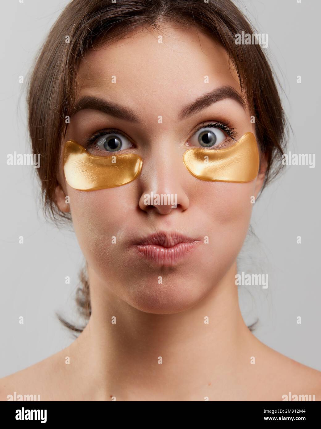 Grimace. Close up beauty portrait of happy beautiful woman applying ...