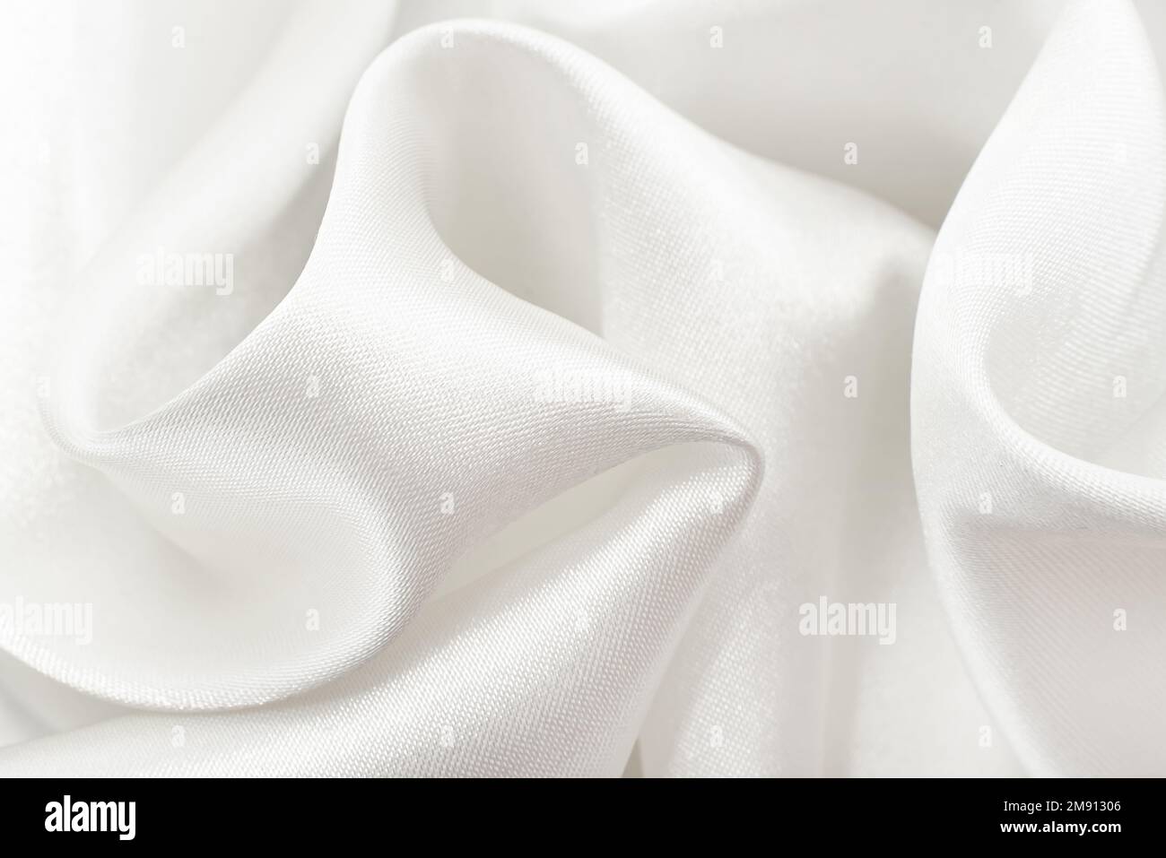 The texture of a fabric made of silk or calico with waves and rumples ...