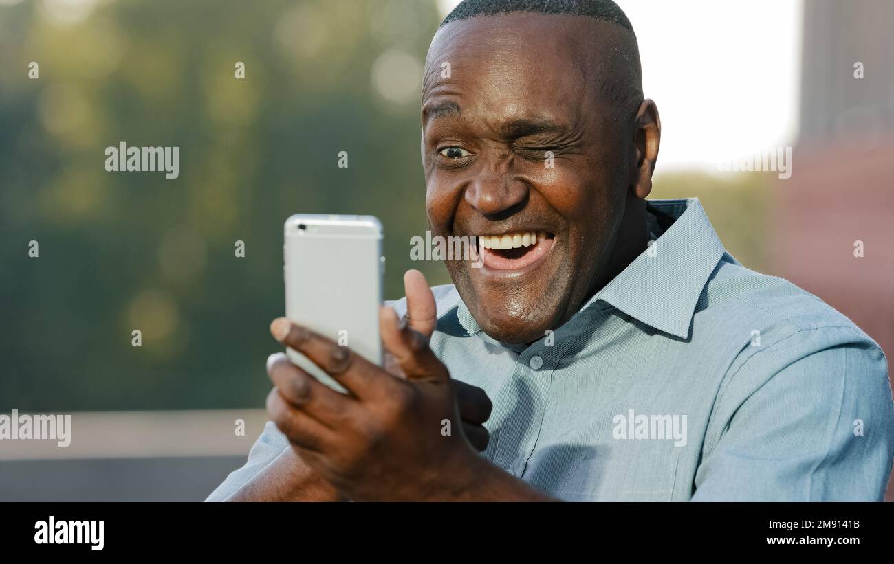 Elderly senior mature African American man talk with smartphone chat ...