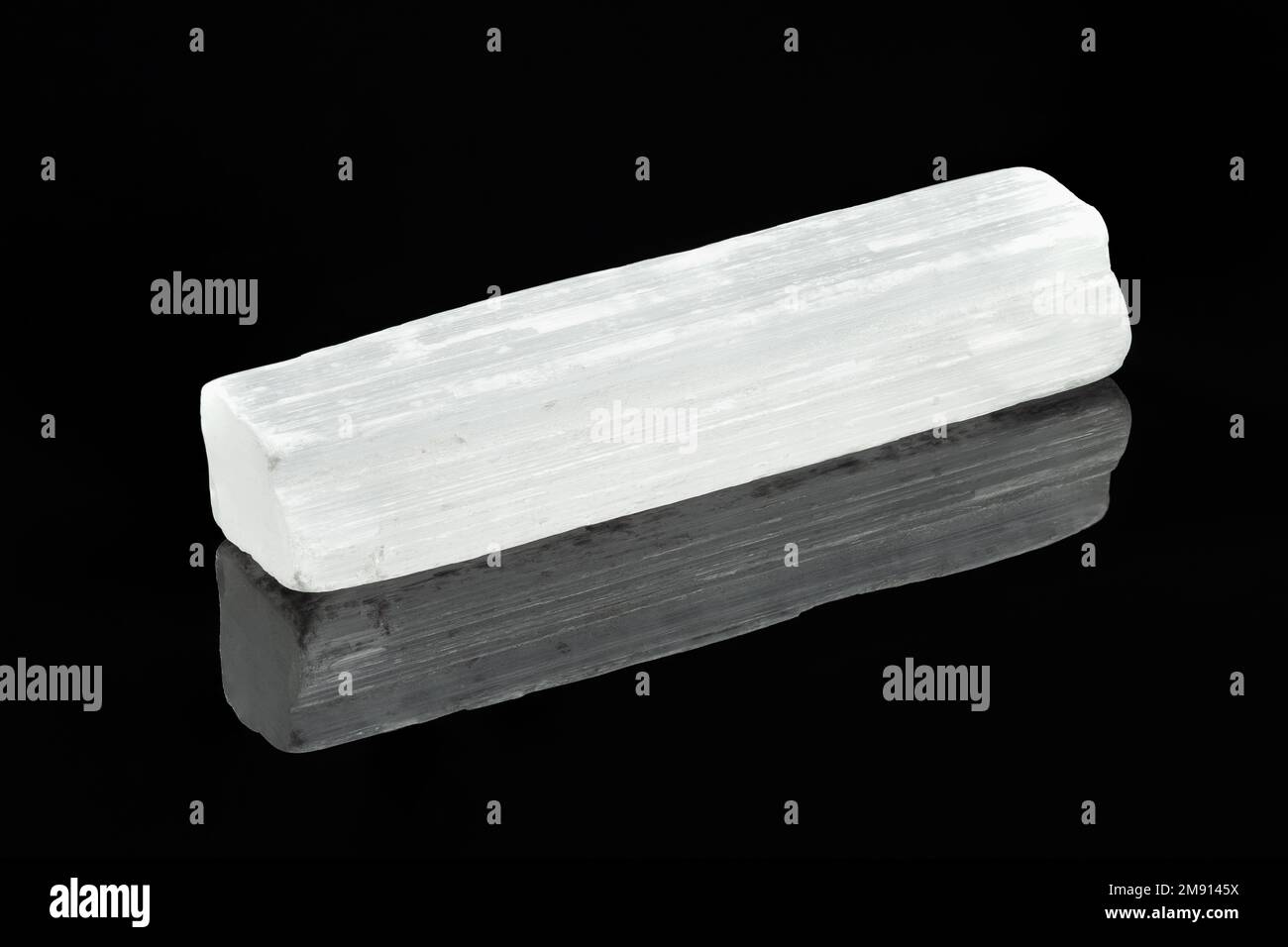 White Selenite Crystal Rod Close Up on Black Background with Reflection ...