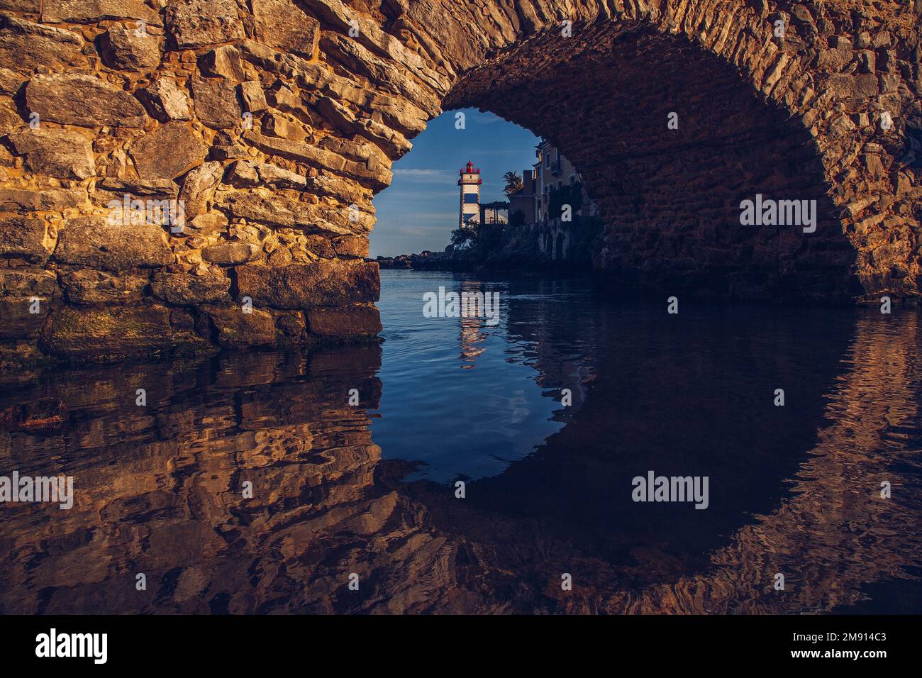 A landscape view with water under the stone arched bridge reflecting ...