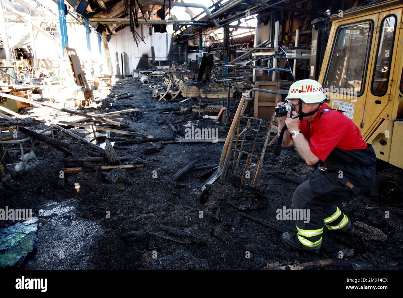 A rescue commander inside a building after a fire Stock Photo - Alamy