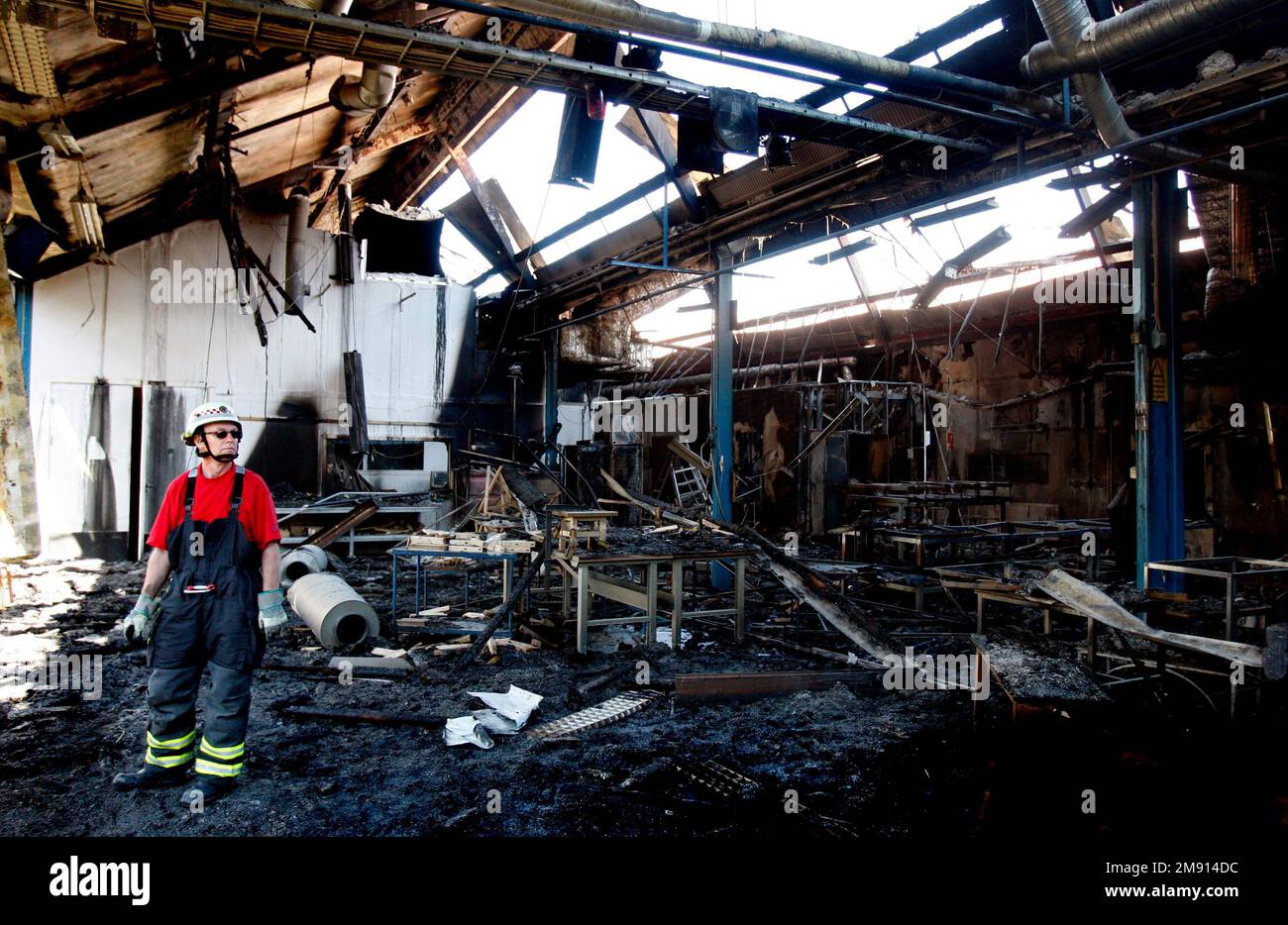 A rescue commander inside a building after a fire Stock Photo - Alamy