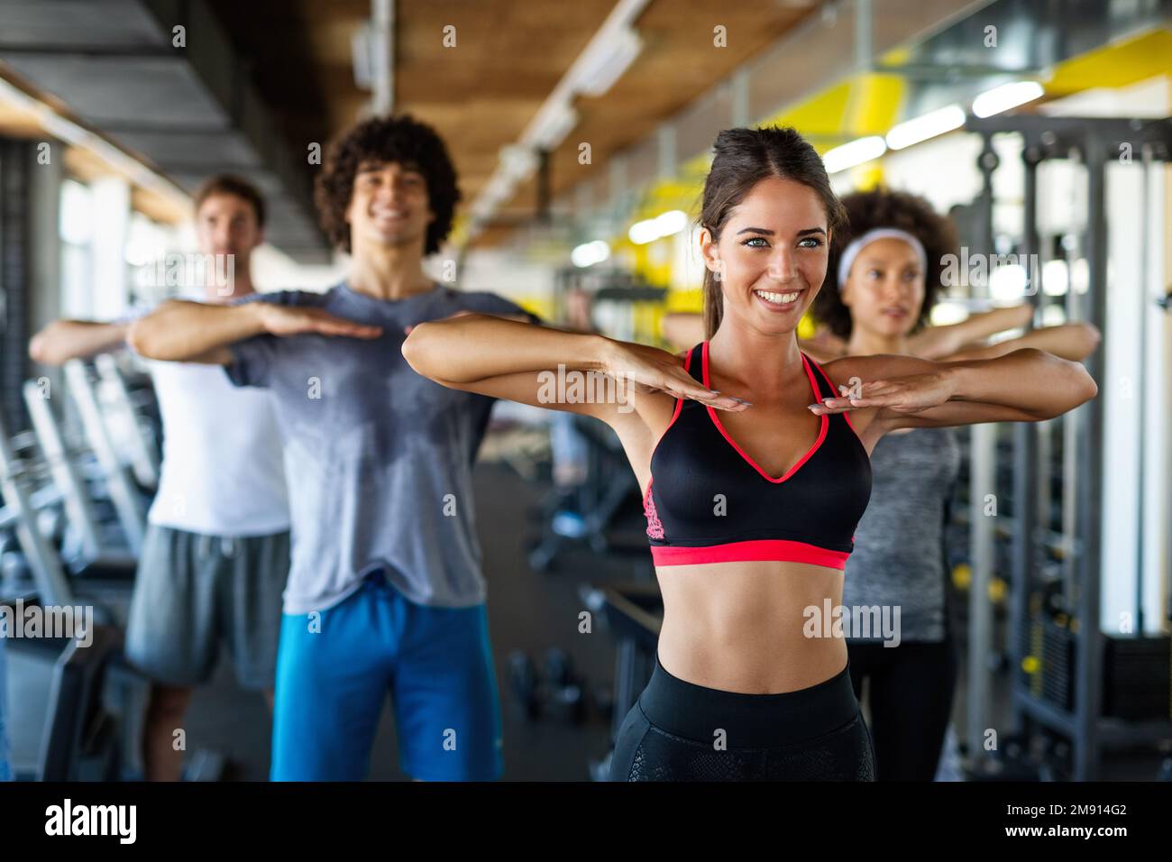 Group of young people, friends smiling and enjoy sport in gym. People ...