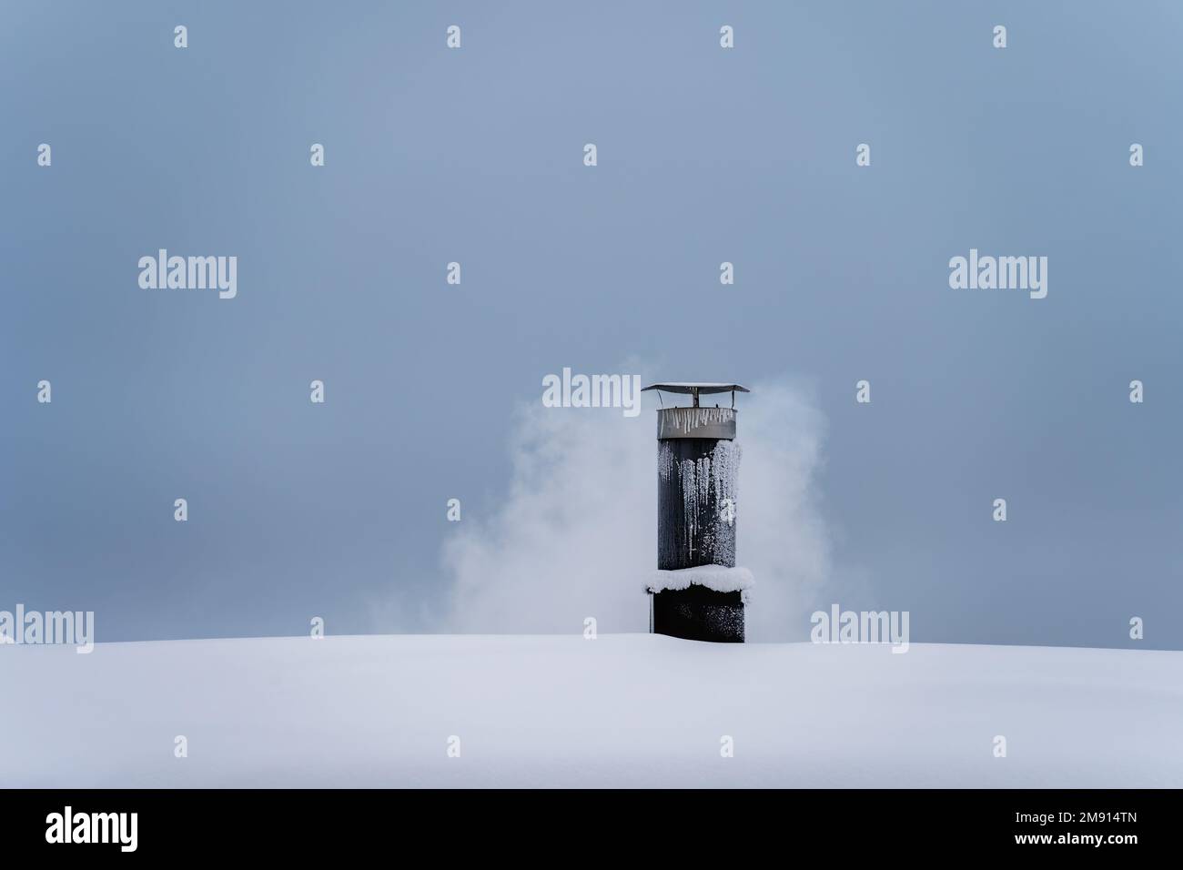 Smoke coming out of metallic chimney on a cold winter day with copy ...