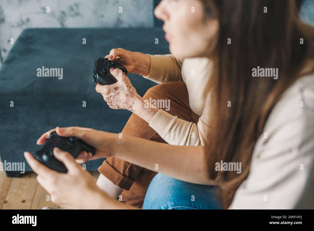 Senior older woman family having fun enjoying playing video game using ...