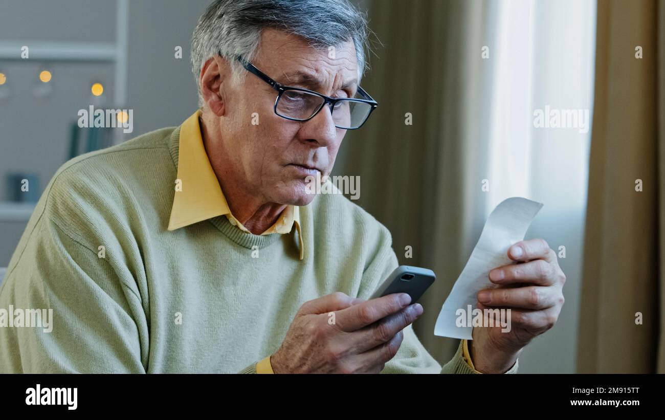 Caucasian old 60s man senior mature grandfather holding smart phone ...