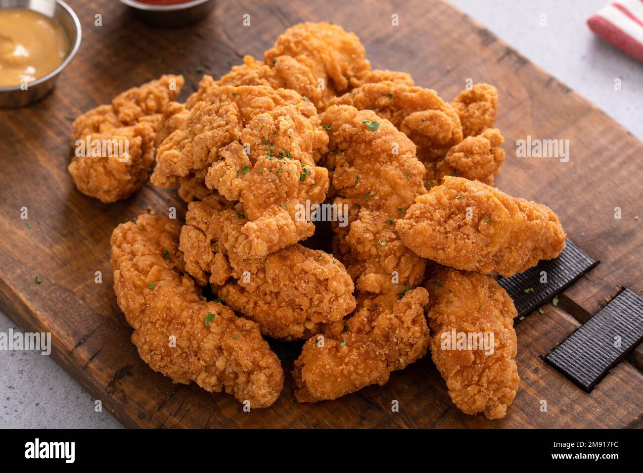 Fried chicken tenders or strips with sauces and fries Stock Photo - Alamy