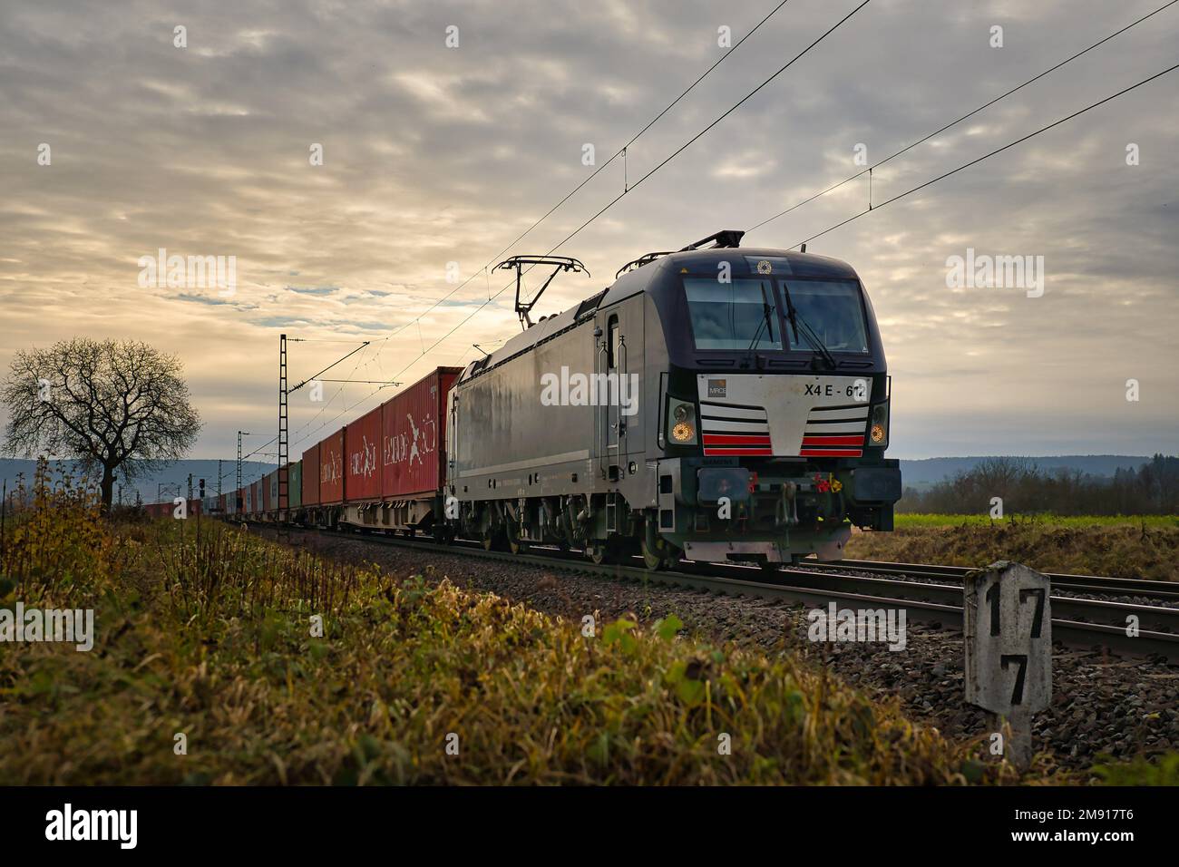 A train on the railway track at sunset Stock Photo - Alamy