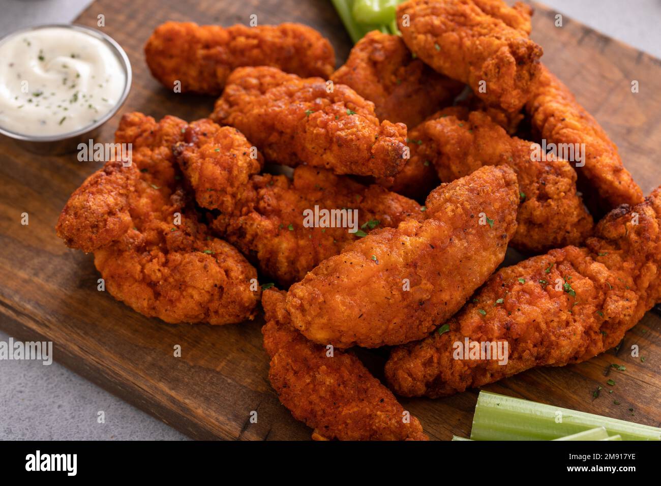 Buffalo chicken fingers served with celery and ranch Stock Photo - Alamy