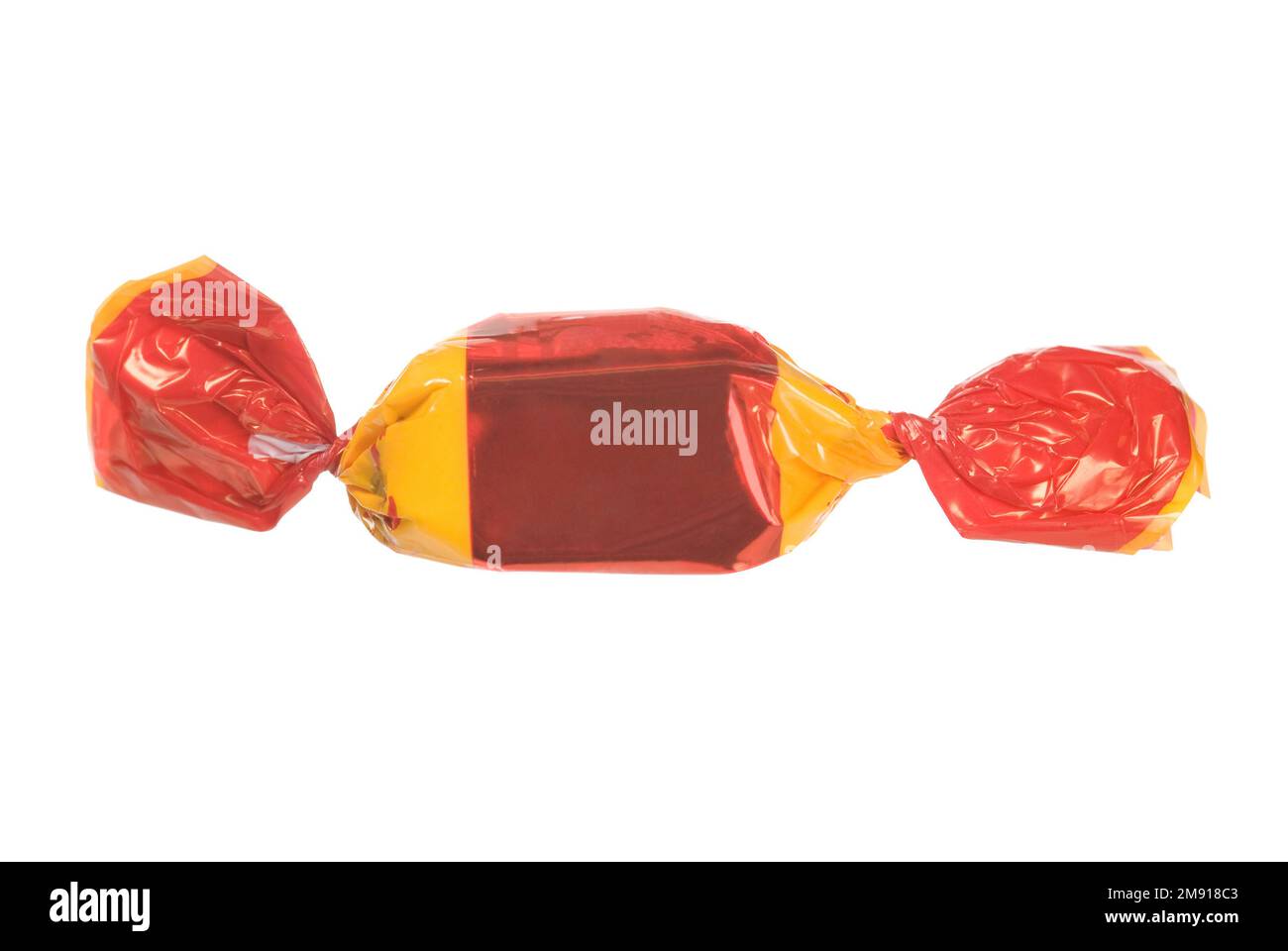 A candy wrapped in a forfeit on white Stock Photo - Alamy