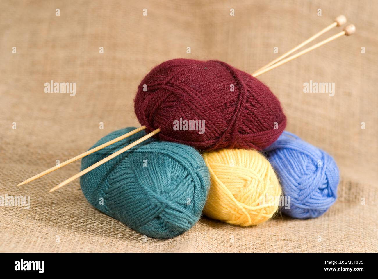Different colors balloons of yarn with knitting needles Stock Photo - Alamy
