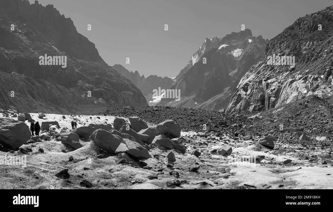 The glacial stream on the glacier Mer de Glace with the Garand Jorasses ...