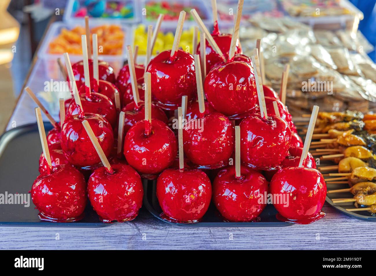 Red Candy Apples on Stick for Sale at Winter Carnival Stock Photo - Alamy