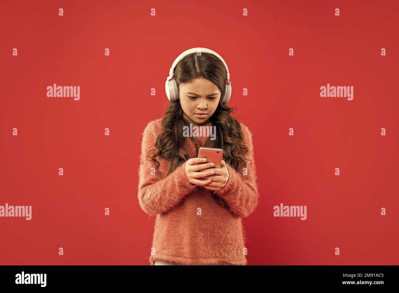 busy teen girl in earphones messaging smartphone. modern life in ...