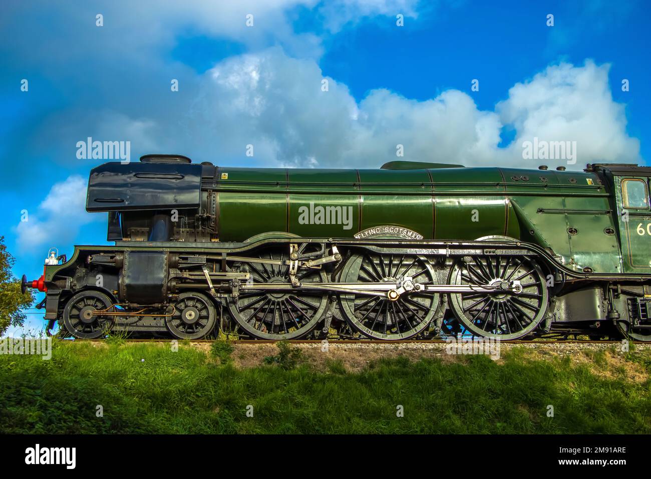 A side view of the old-fashioned Flying Scotsman train against the blue ...