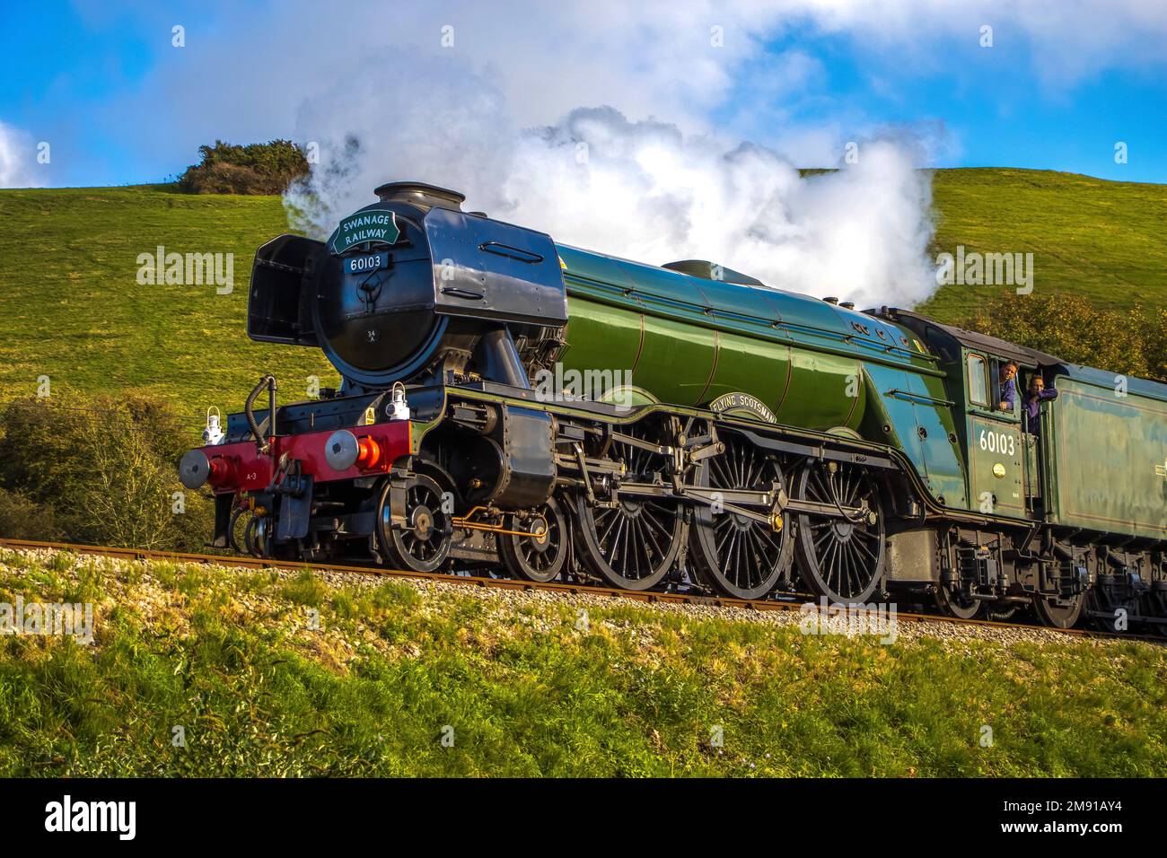 The old-fashioned Flying Scotsman train steaming on the railway Stock ...