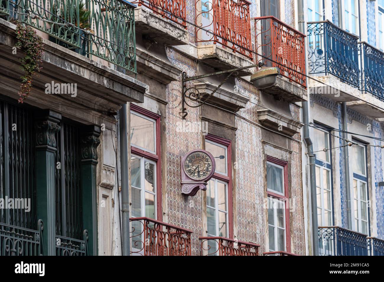 Vintage dilapidated wall mounted clock on classic Portugues ...