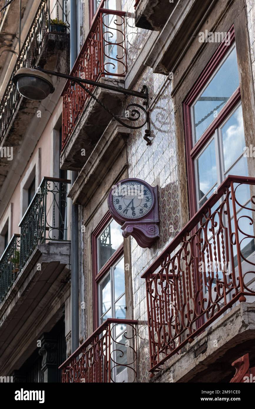 Vintage dilapidated wall mounted clock on classic Portugues ...
