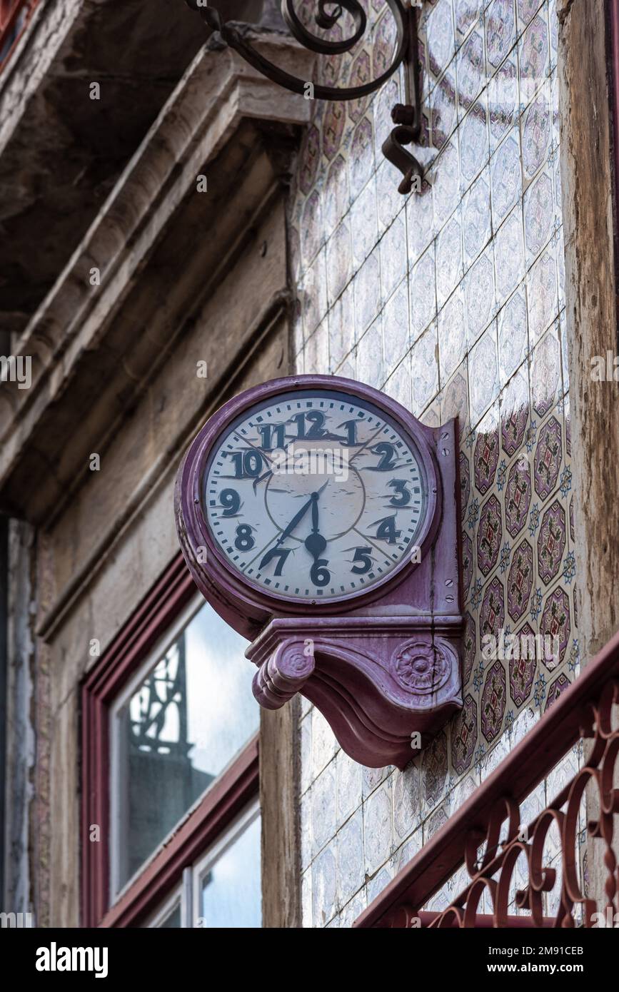 Vintage dilapidated wall mounted clock on classic Portugues ...
