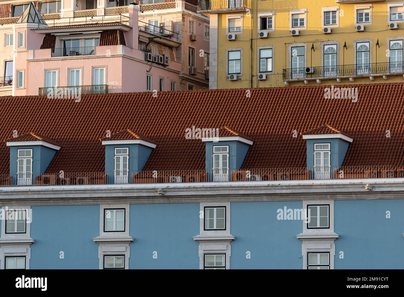 Close-up of several different coloured traditional apartment buildings ...