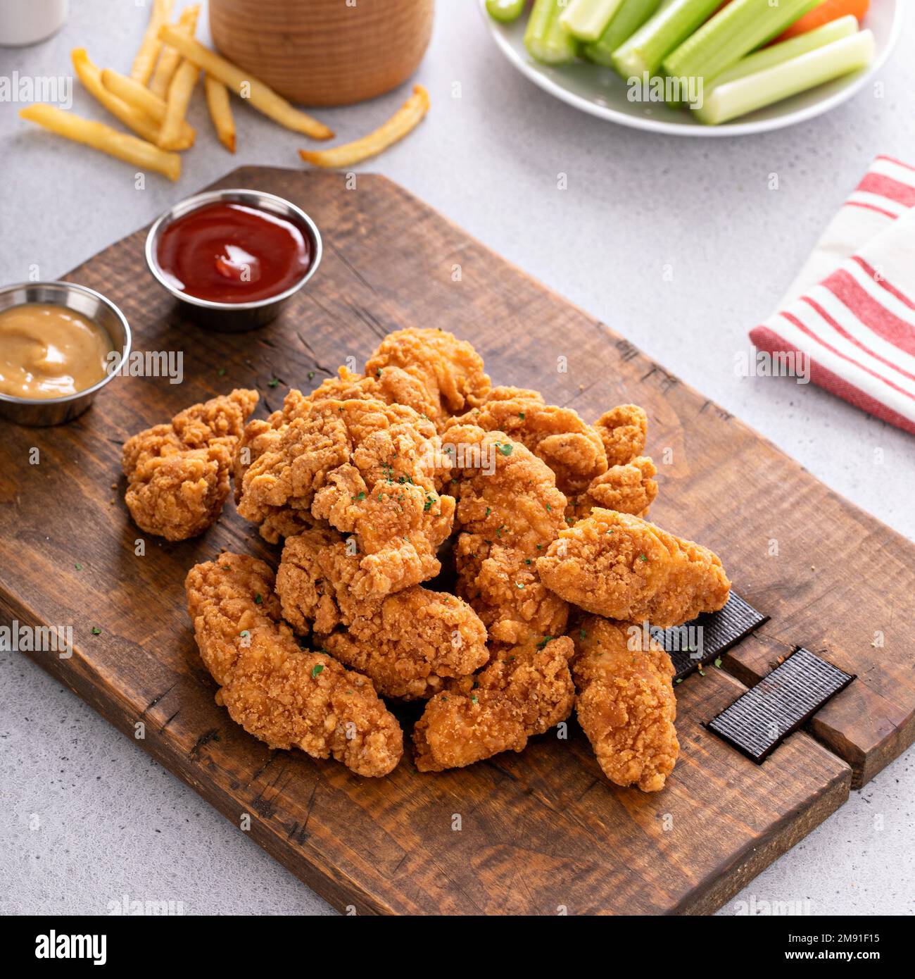 Fried chicken tenders or strips with sauces and fries Stock Photo - Alamy