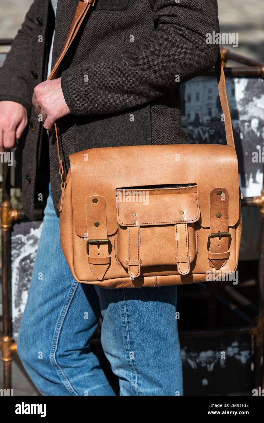 Part photo of a man with a yellow leather briefcase with antique and ...