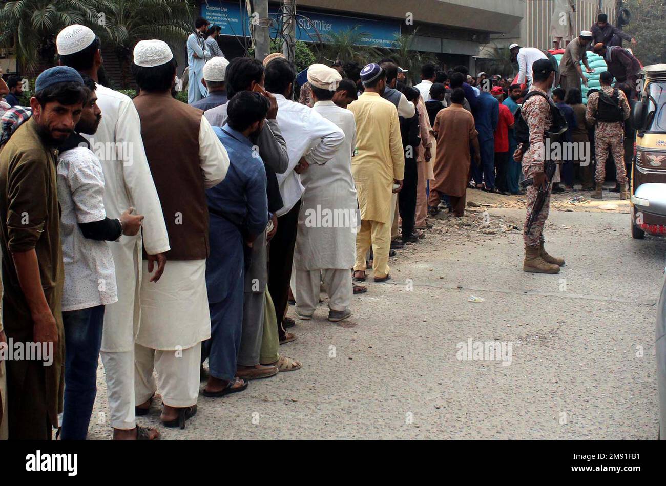People gather for buying flour bags on subsidies price from a mobile ...