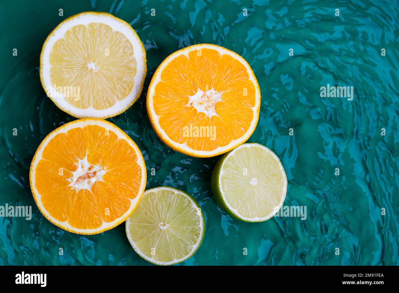 Citrus fruits in green water background with concentric circles and ...