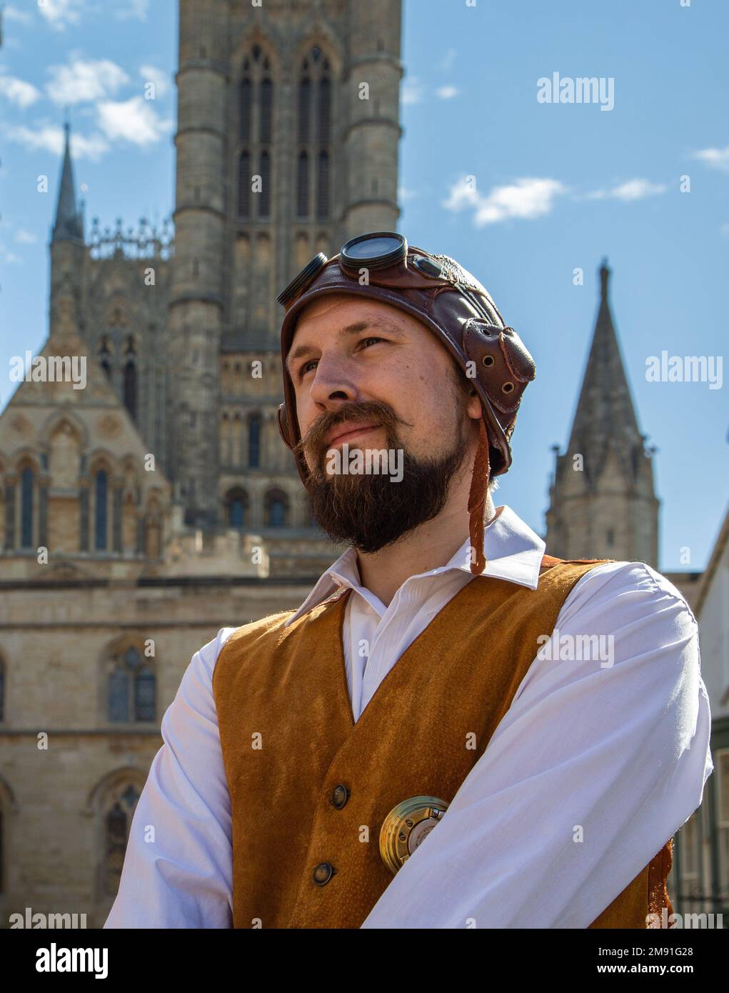 Heroic portrait of a man with a beard wearing an old flight helmet ...